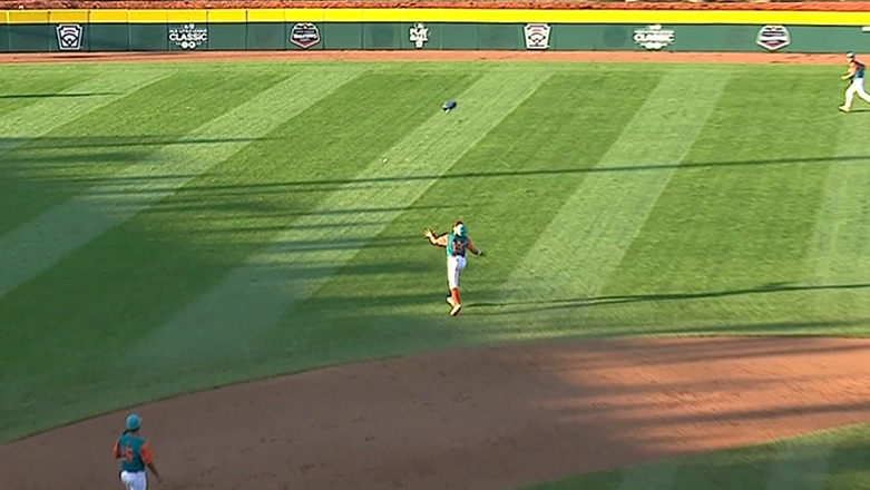 Little League shortstop throws his glove in attempt to stop the base ...